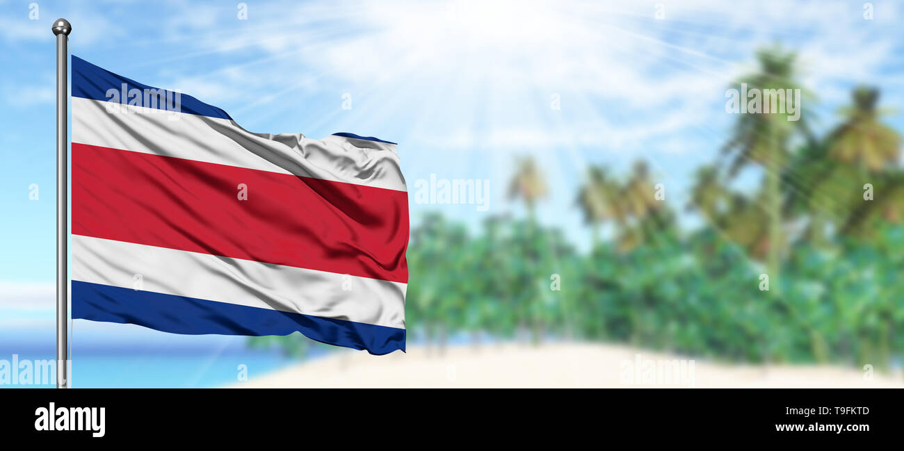 Waving Costa Rica flag in the sunny blue sky with summer beach ...