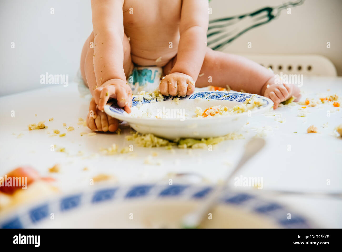 Baby feet dirty with food after lunch Stock Photo - Alamy