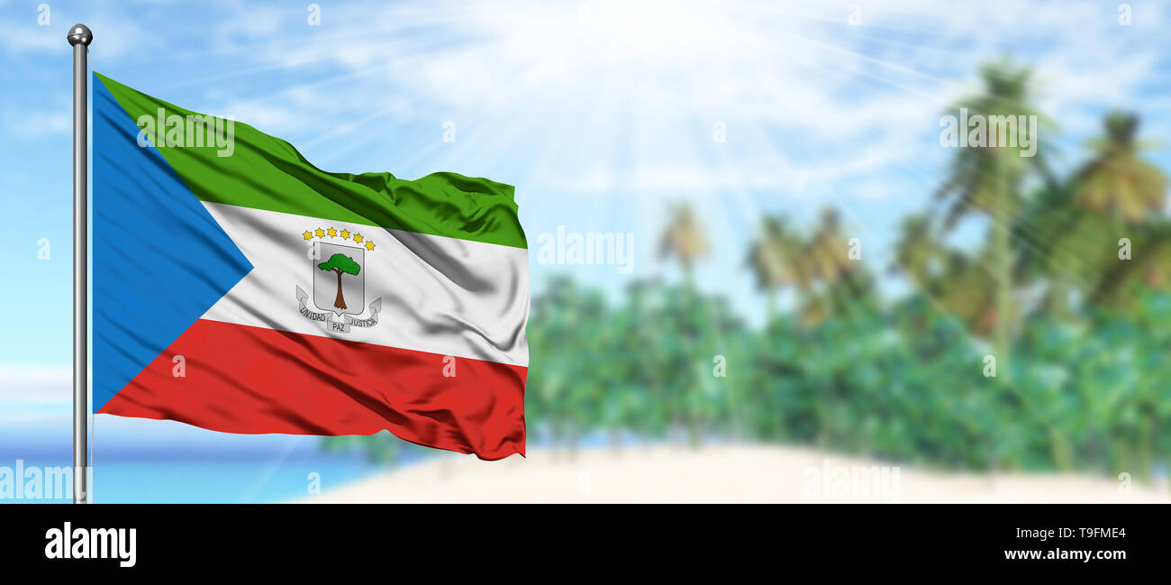 Waving Equatorial Guinea flag in the sunny blue sky with summer beach ...