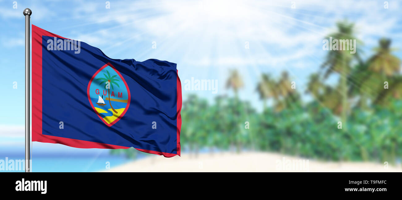 Waving Guam flag in the sunny blue sky with summer beach background ...