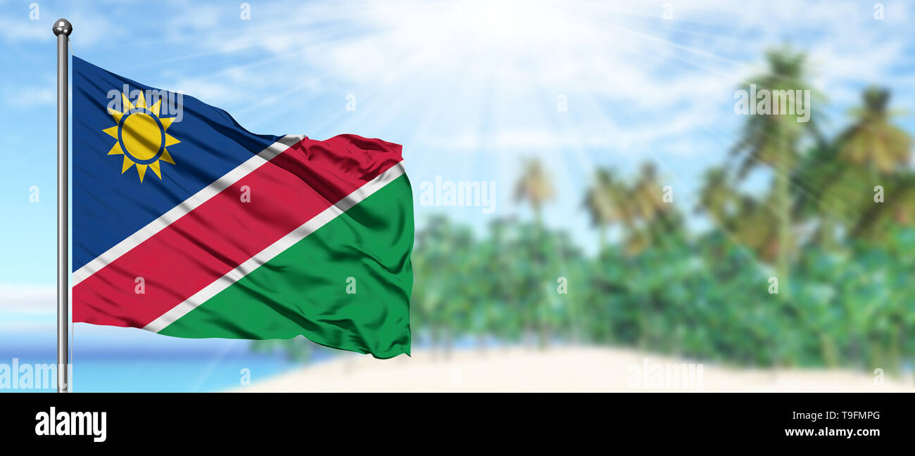 Waving Namibia flag in the sunny blue sky with summer beach background ...