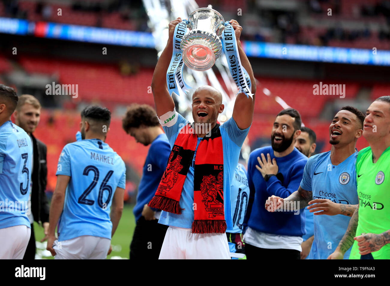 Manchester City's Vincent Kompany (centre) celebrates with the trophy ...