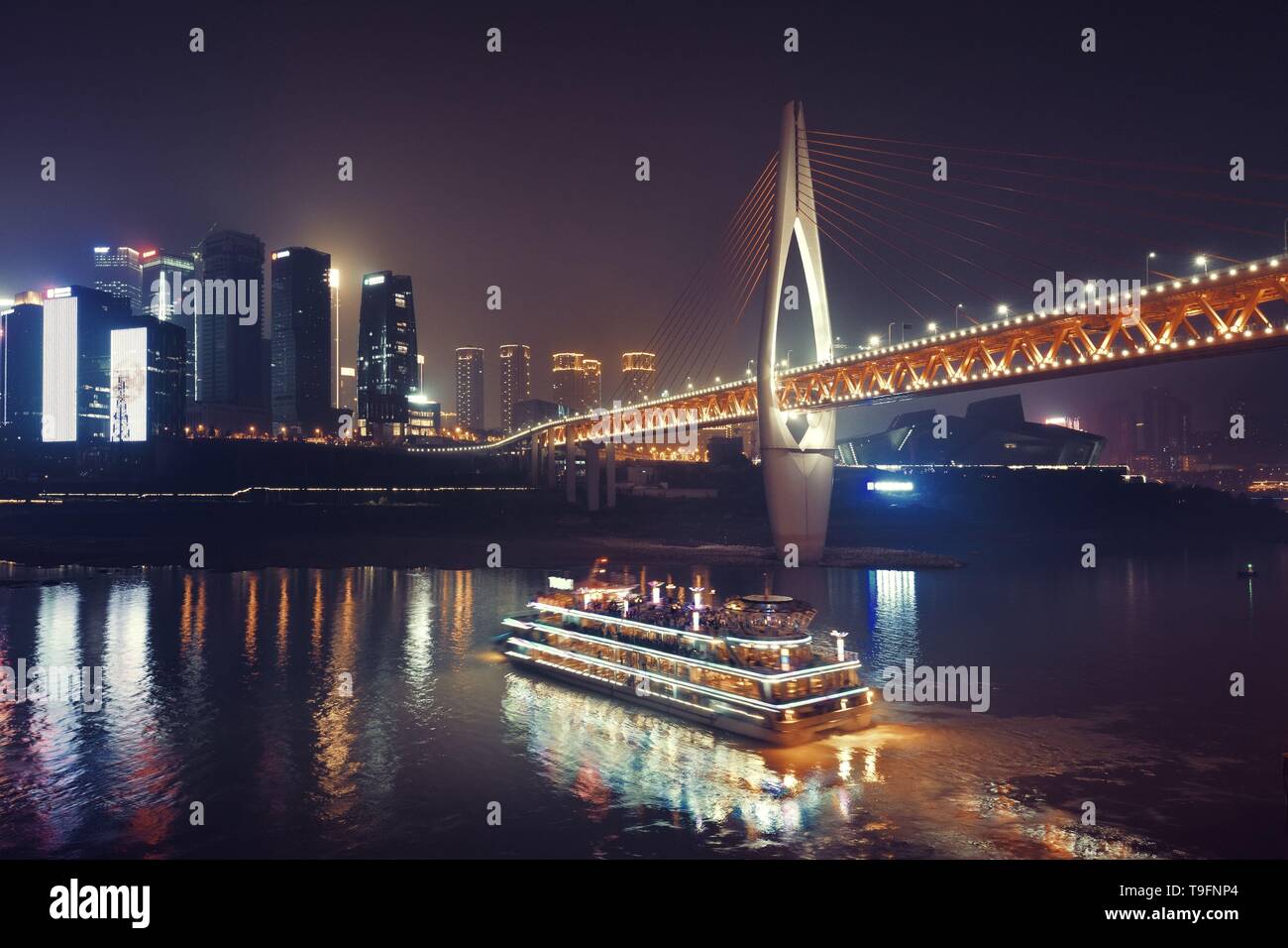 Bridge boat and city urban architecture at night in Chongqing, China ...