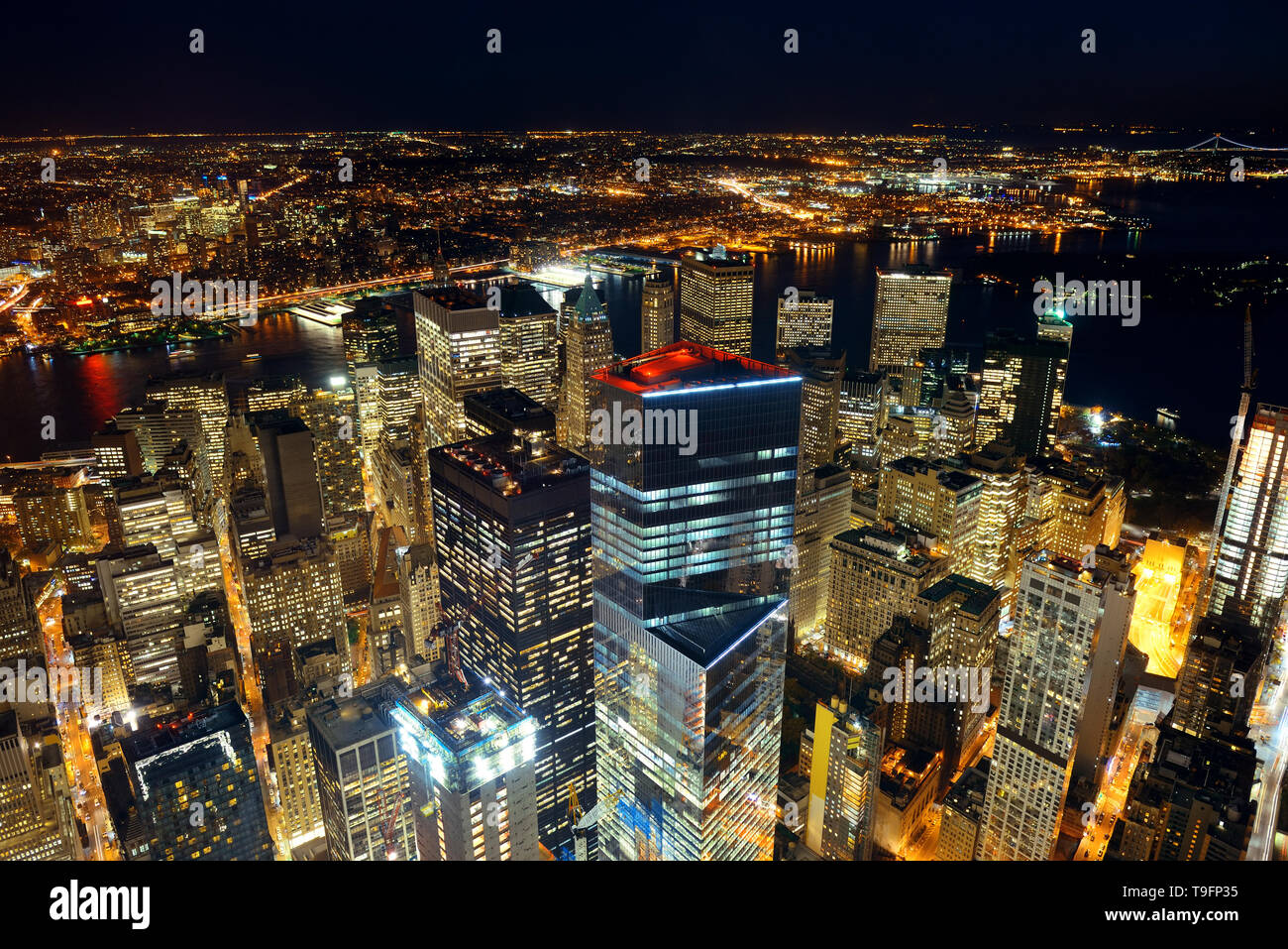 Rooftop night view of New York City downtown with urban skyscrapers ...