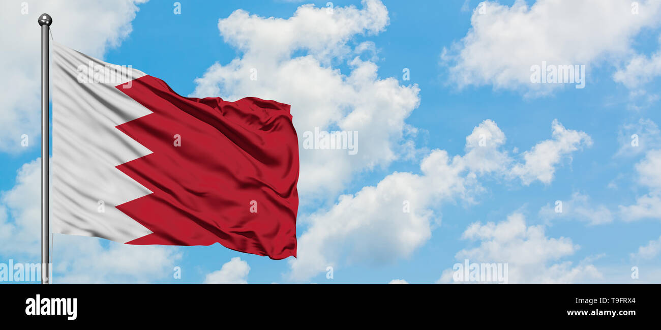 Bahrain flag waving in the wind against white cloudy blue sky ...