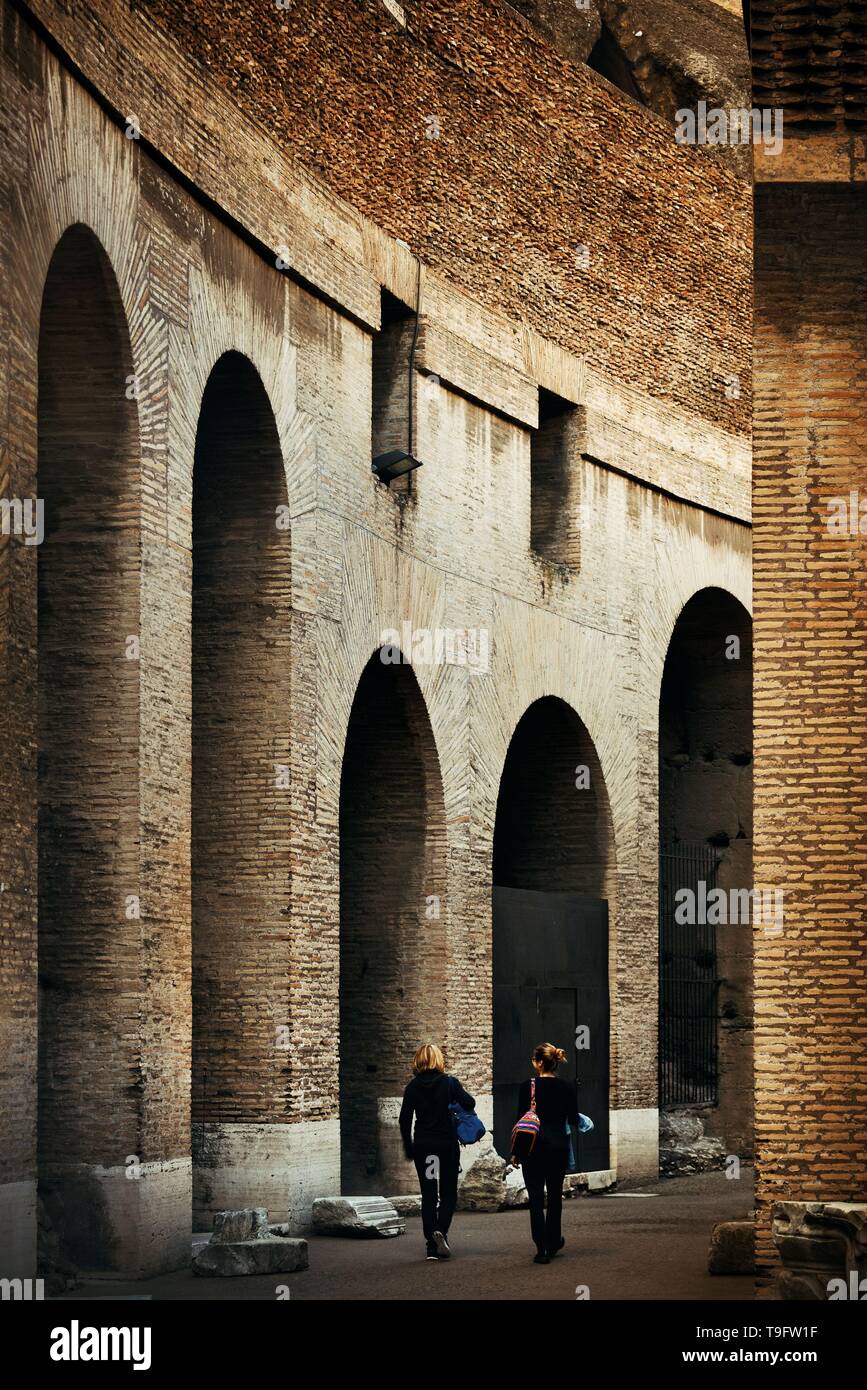 Tourists walk with Archway in Colosseum, the world known landmark and ...