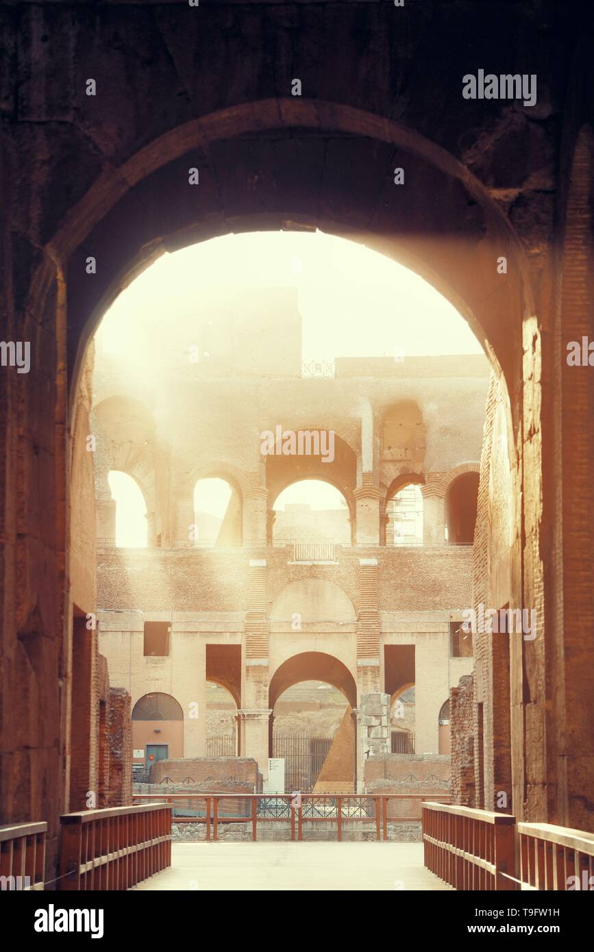 Archway in Colosseum at sunset, the world known landmark and the symbol ...