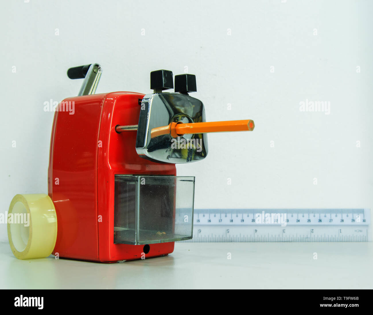 Red pencil sharpener machine on white background Stock Photo - Alamy