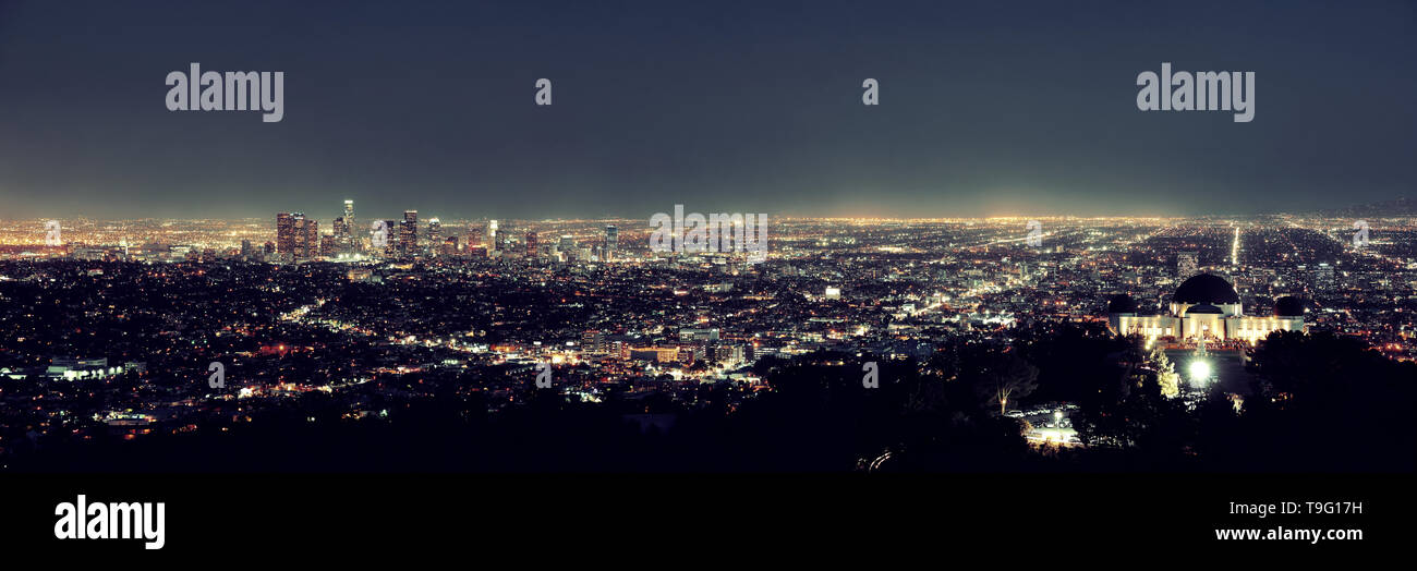 Los Angeles at night with urban buildings and Griffith Observatory ...