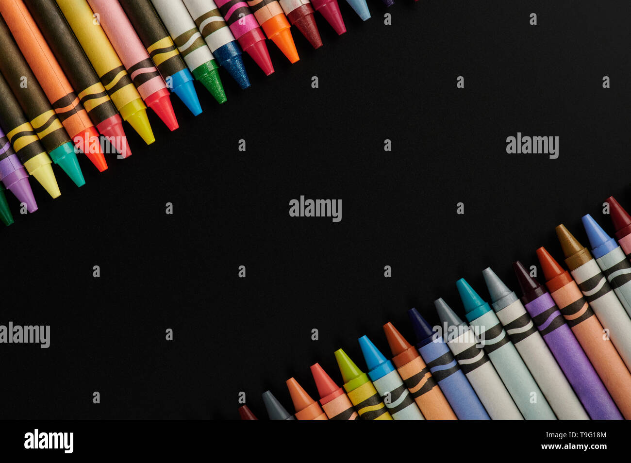 Colorful crayon frame with black board background Stock Photo - Alamy