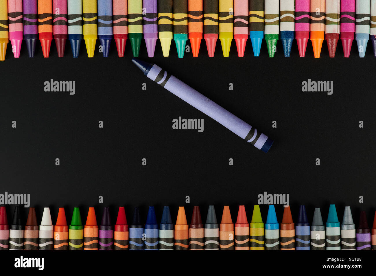 Blue crayon in colorful frame on black board background Stock Photo - Alamy