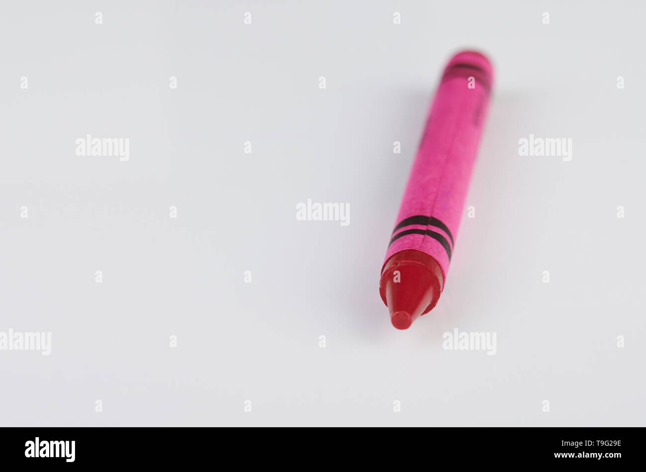 One red crayon isolated on white background close up Stock Photo - Alamy