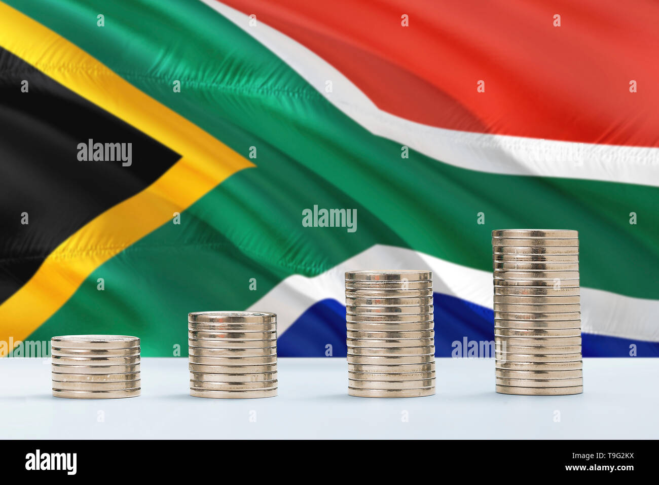 South Africa flag waving in the background with rows of coins for ...