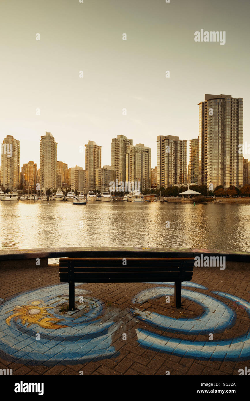 A bench at Vancouver waterfront with apartment buildings Stock Photo ...