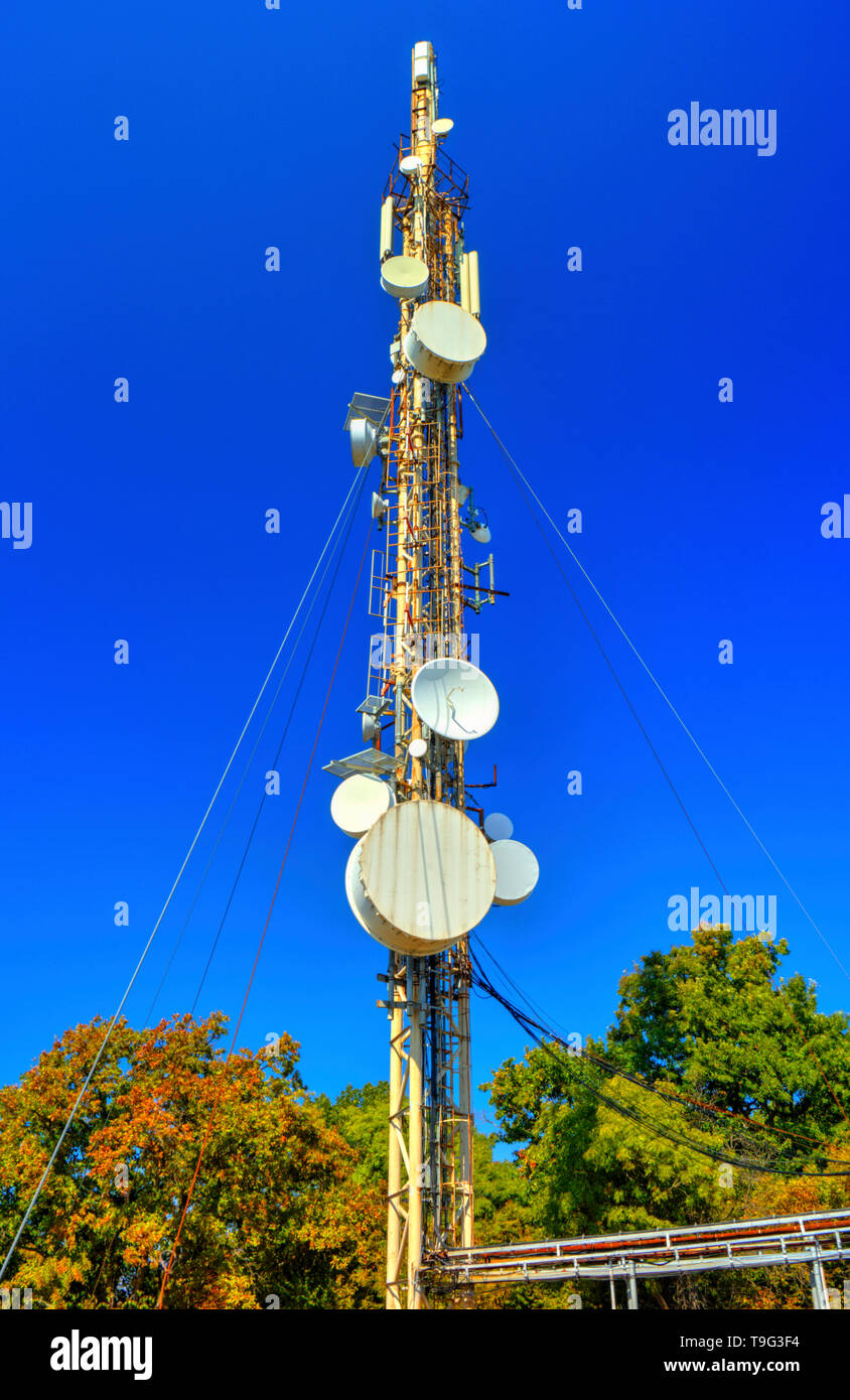 Communication antenna tower on blue sky Stock Photo - Alamy