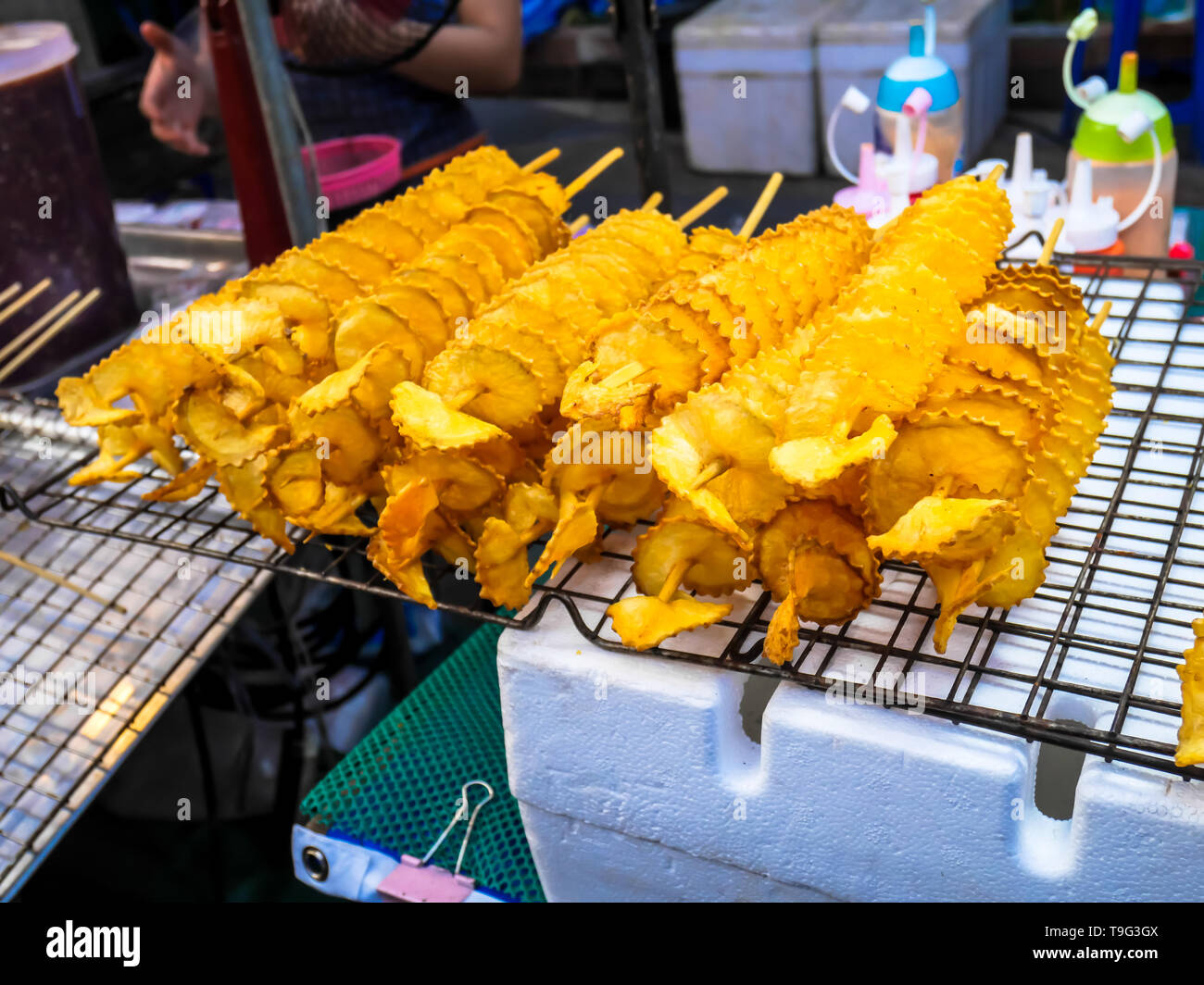 Spiral potatoes fried, on wooden sticks, spiral. Selling food at the market Stock Photo - Alamy