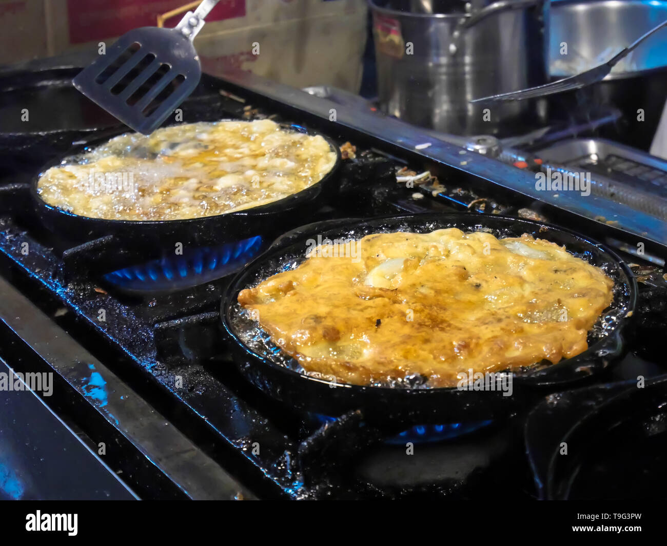 Cooking fried shellfish with been sprouts (Thai food) in the steel pan ...