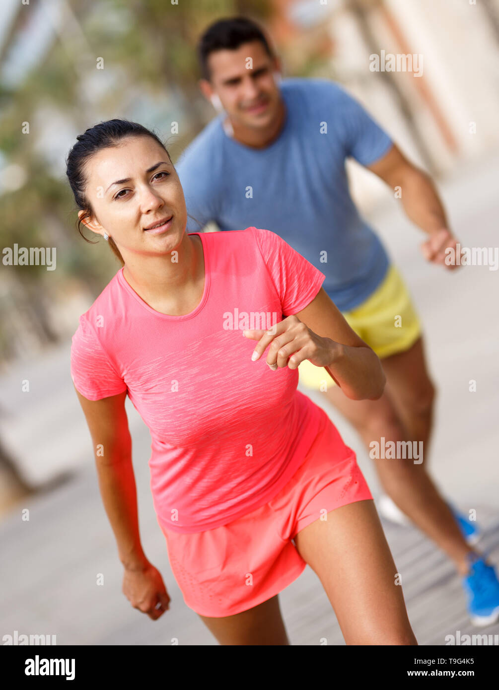 Two active friends running at morning city landscape enjoying healthy ...