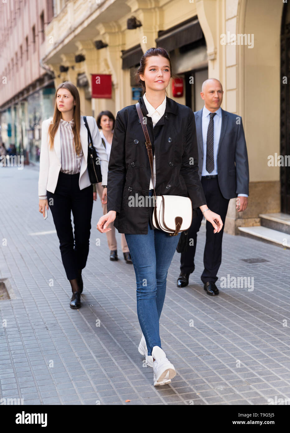People in formal wear walking down street in the big city Stock Photo ...