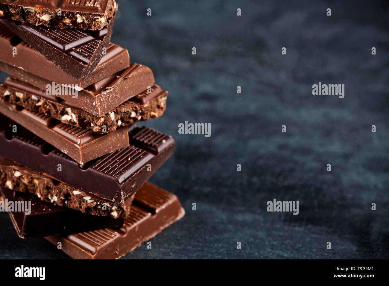 Chocolate bar pieces closeup. Sweet food photo concept with copy space ...