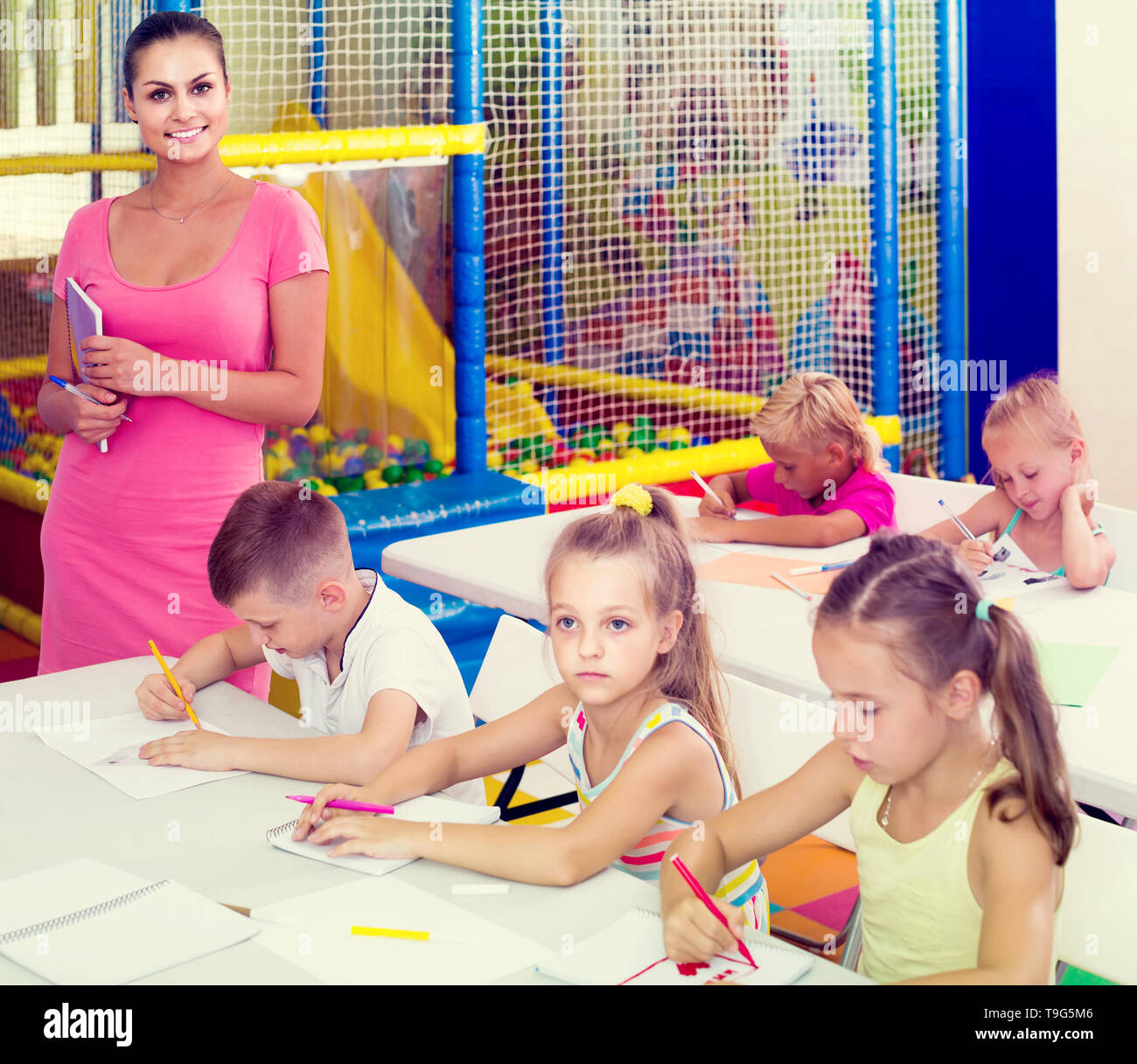 positive american children sitting together and studying in class at ...
