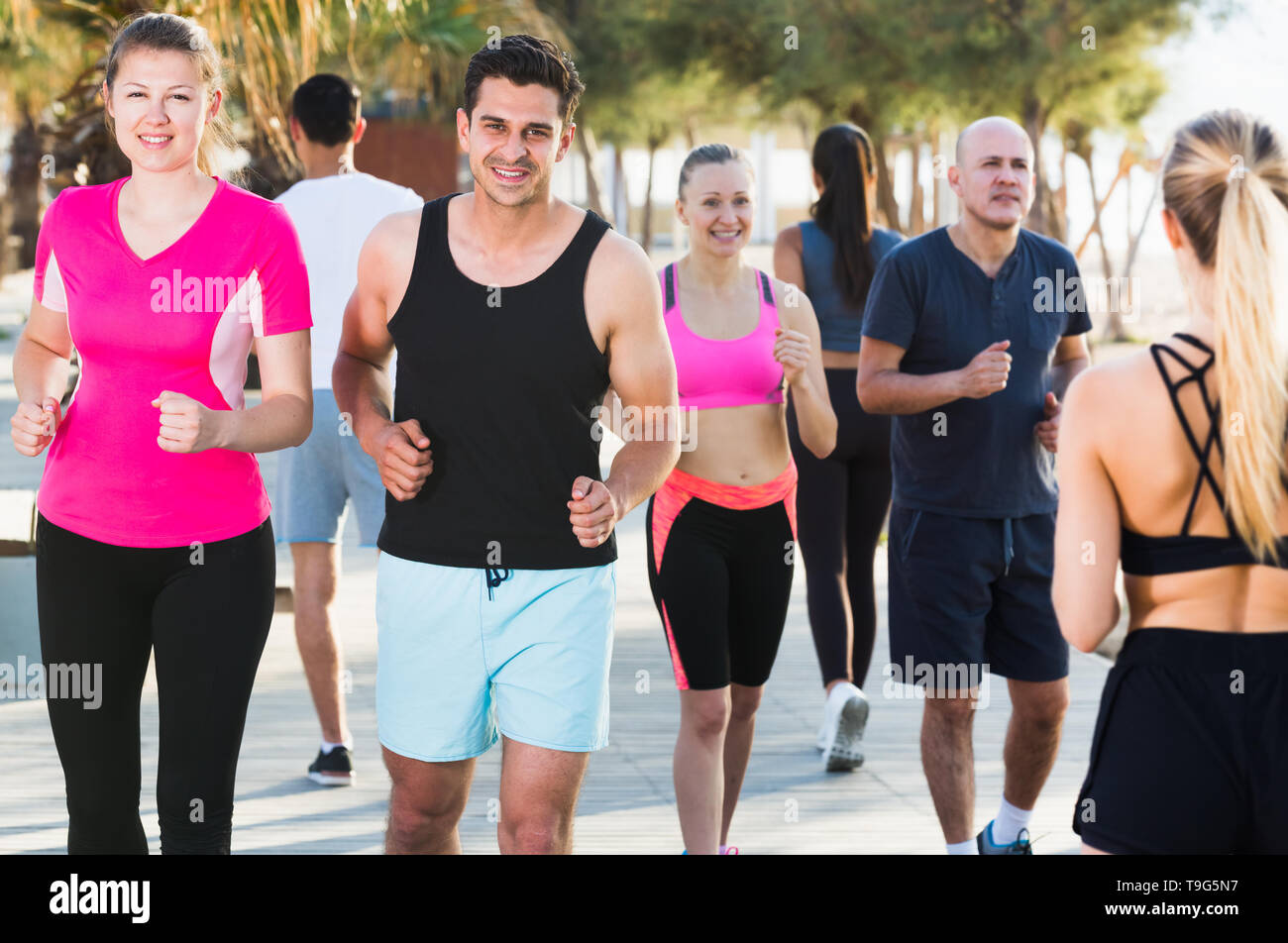 Active smiling people during running training in daytime Stock Photo ...
