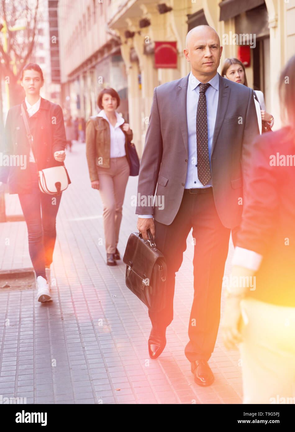 People in a formal wear walking down street at big city Stock Photo - Alamy