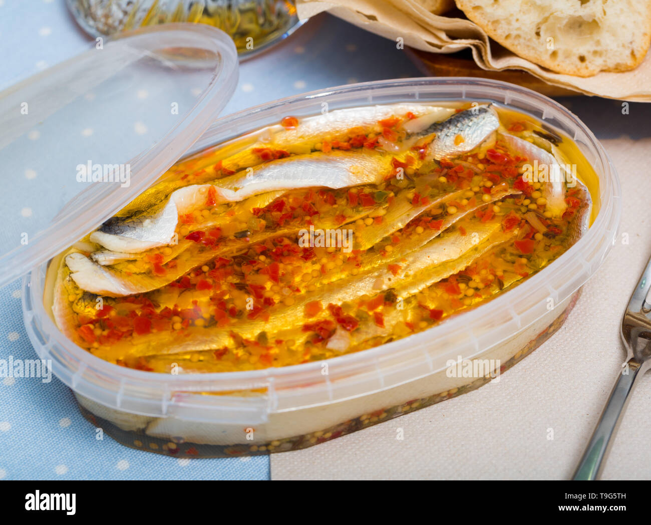 Preserved sardines marinated with spices in plastic container Stock ...