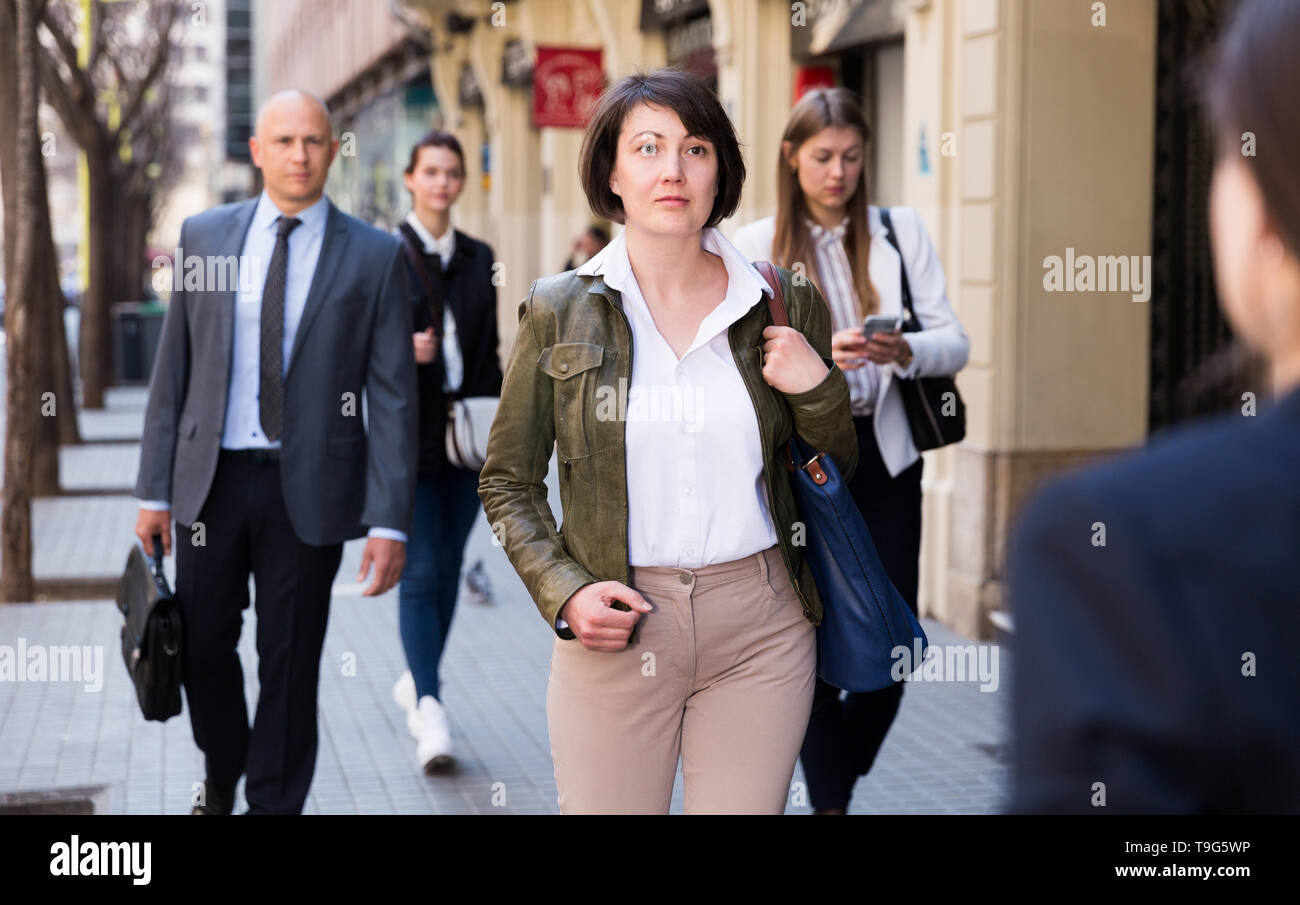 People in formal wear walking down street in big city Stock Photo - Alamy