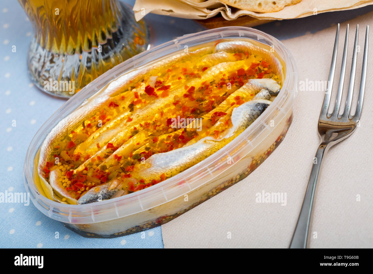 Preserved sardines marinated with spices in plastic container Stock ...