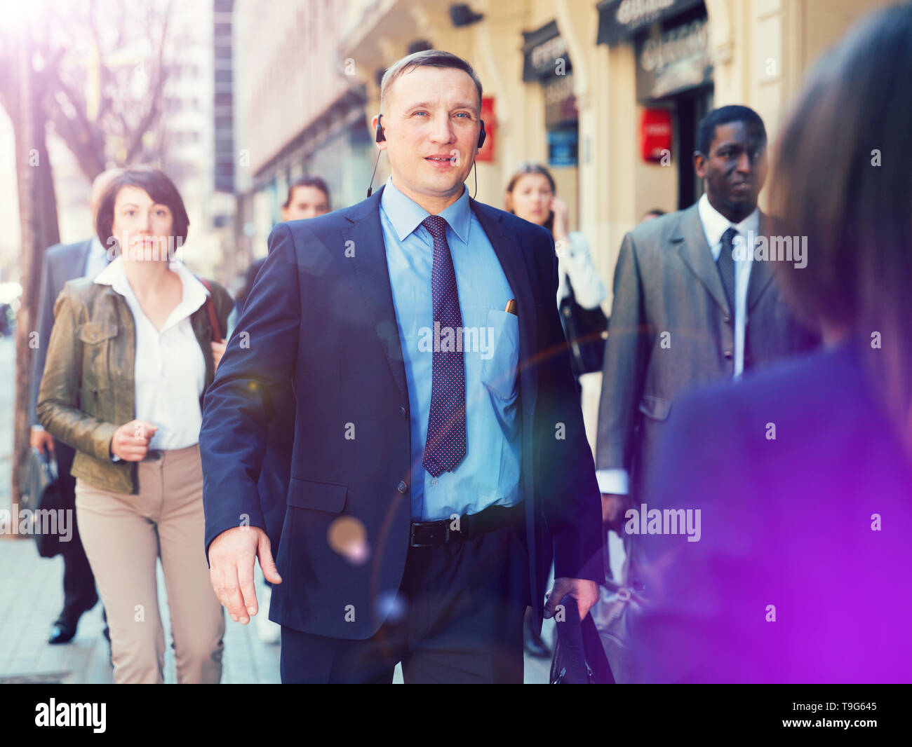 Confident businessman in formal suit walking on city street to office ...