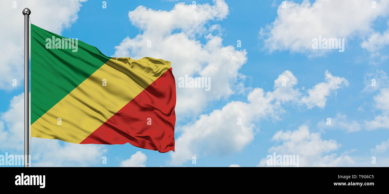 Republic Of The Congo flag waving in the wind against white cloudy blue ...
