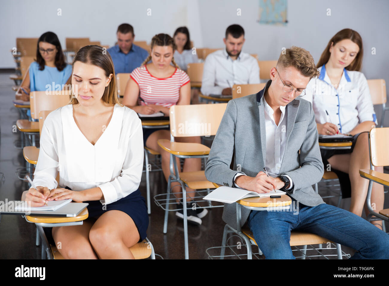 Portrait of group of different age people in lecture hall at extension ...
