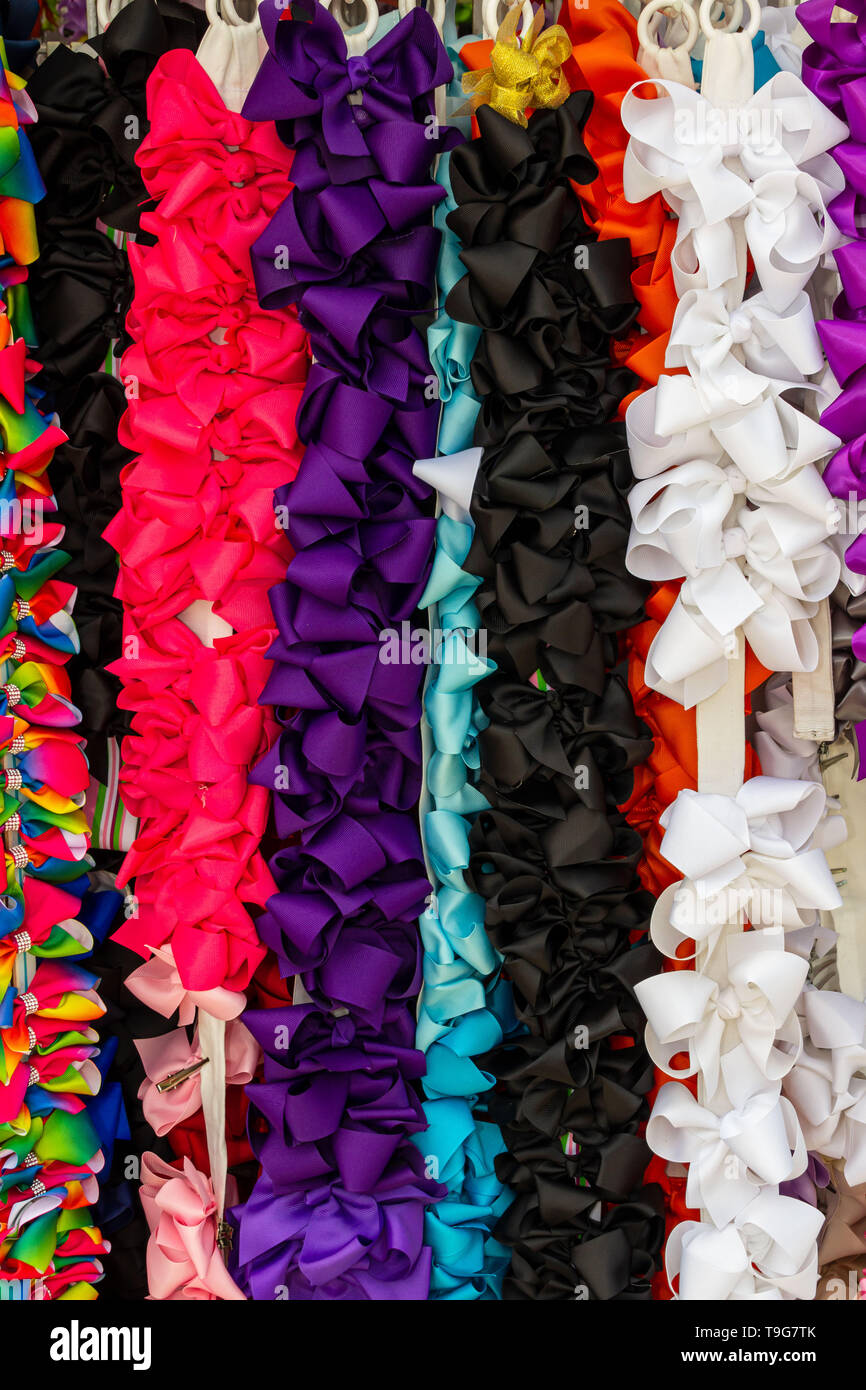 Columns of pink, purple, light blue, black, orange, and white hair bows ...