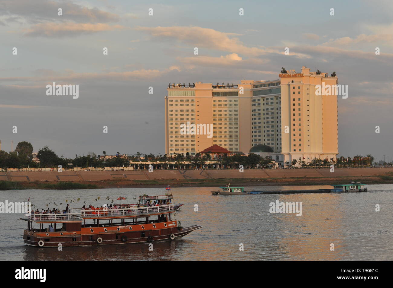A dinner cruise boat. Riverboat traffic on The Tonle Sap River at dusk ...