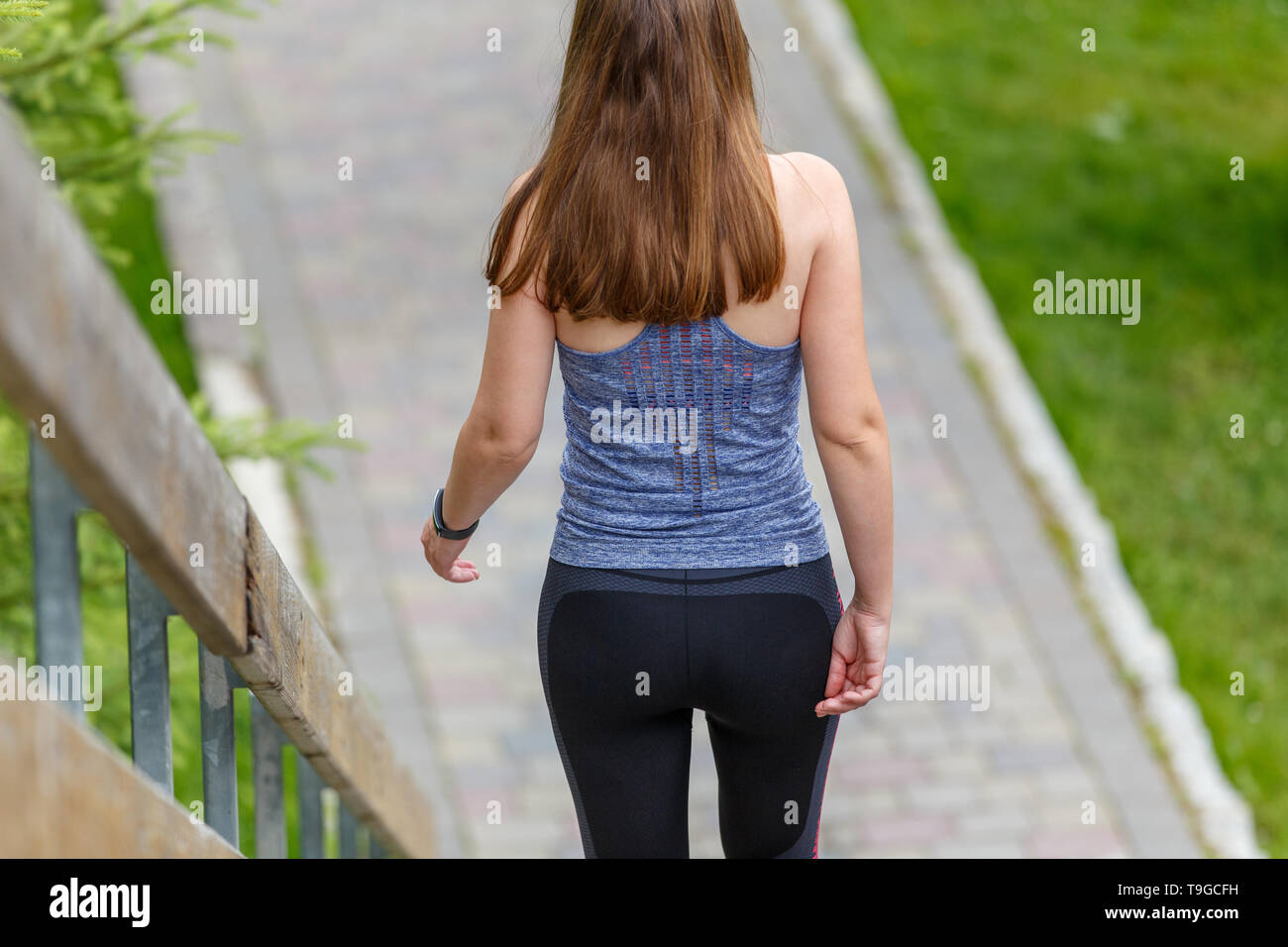 Slim sporty woman descending the stairs outdoor. Healthy lifestyle background Stock Photo - Alamy