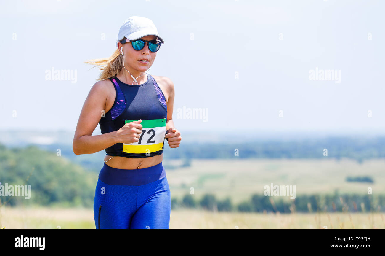 Young slim woman running trail race contest Stock Photo - Alamy