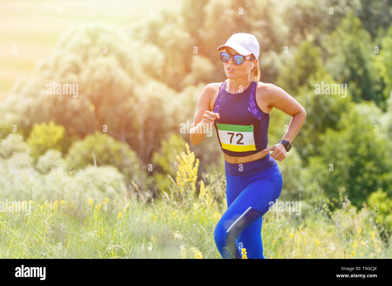 Young slim woman running trail race contest. Image with copy space ...