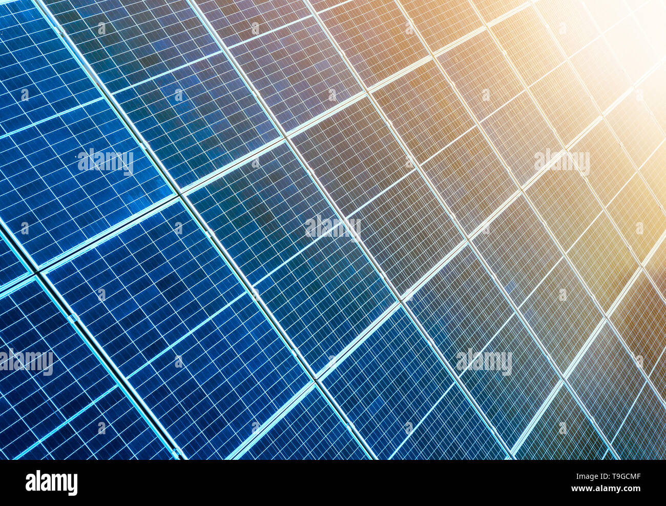 Close-up surface of lit by sun blue shiny solar photo voltaic panels ...