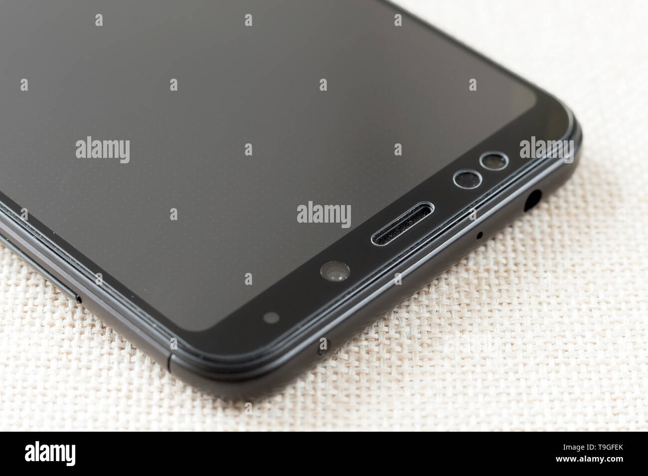 Close-up detai view of cellphone front camera, sensors and loudspeaker ...