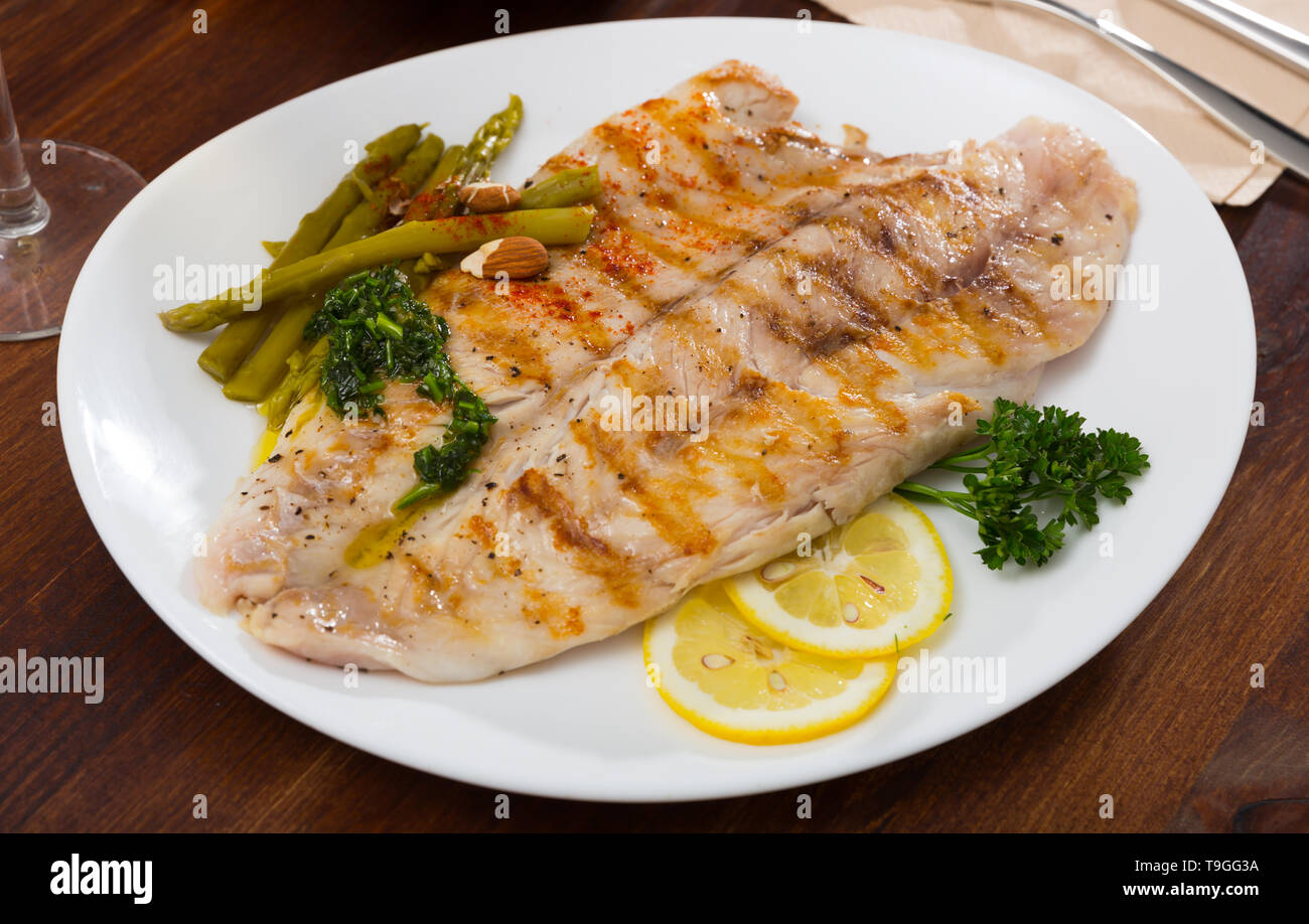 Roasted perch fish fillet served with pickled asparagus and parsley ...