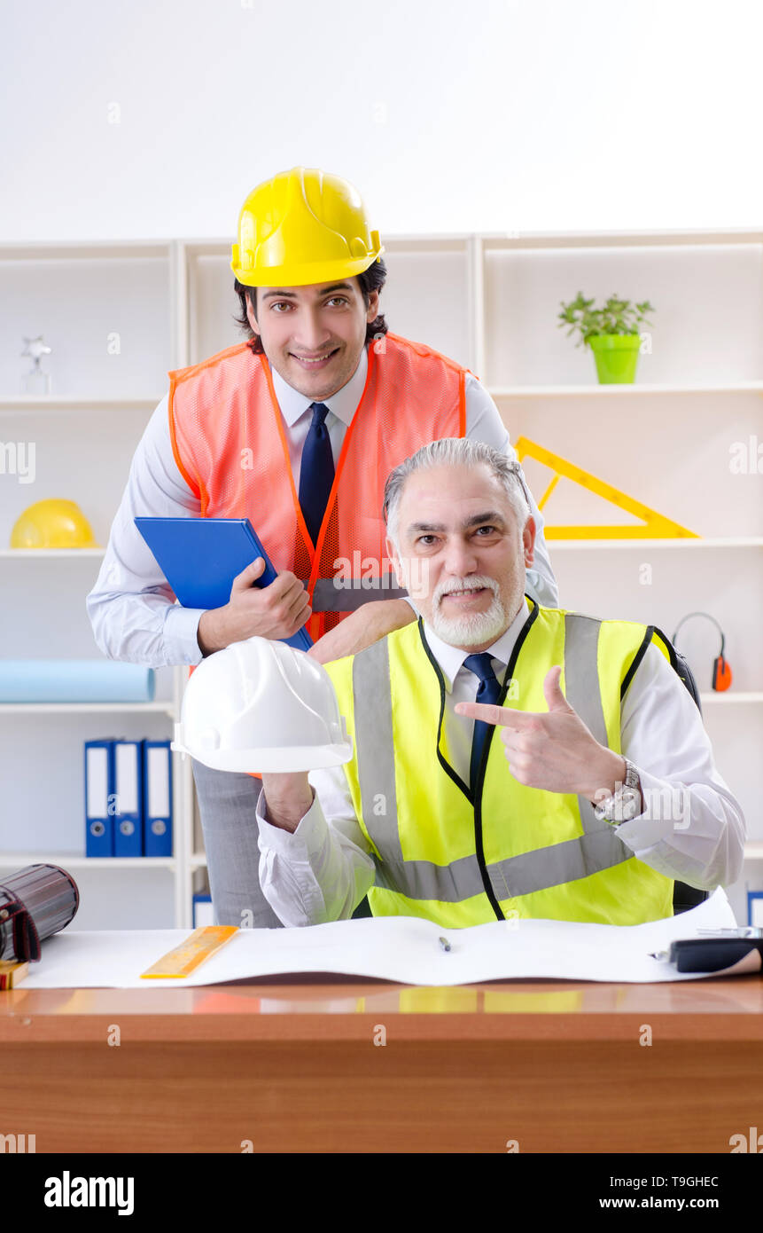 Two engineers colleagues working under project Stock Photo - Alamy