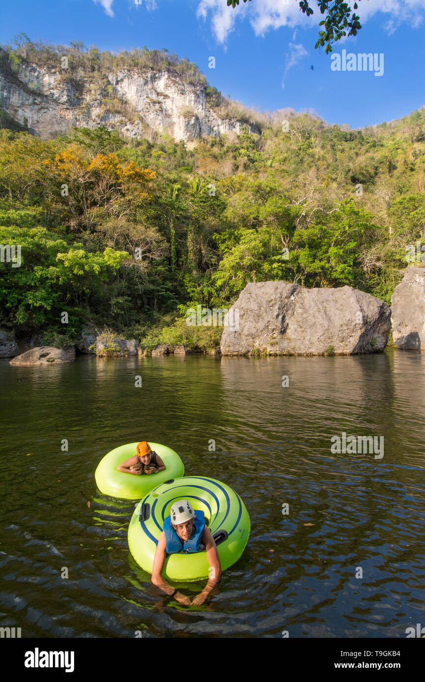 Two teenagers arrive on tubes floating down Macal River, Black Rock ...