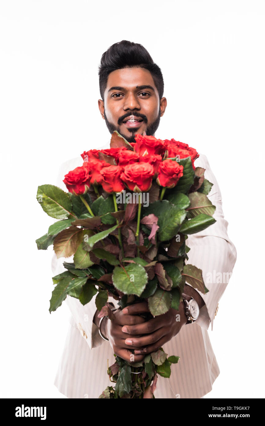 handsome man holding bouquet of red roses, isolated on grey Stock Photo ...