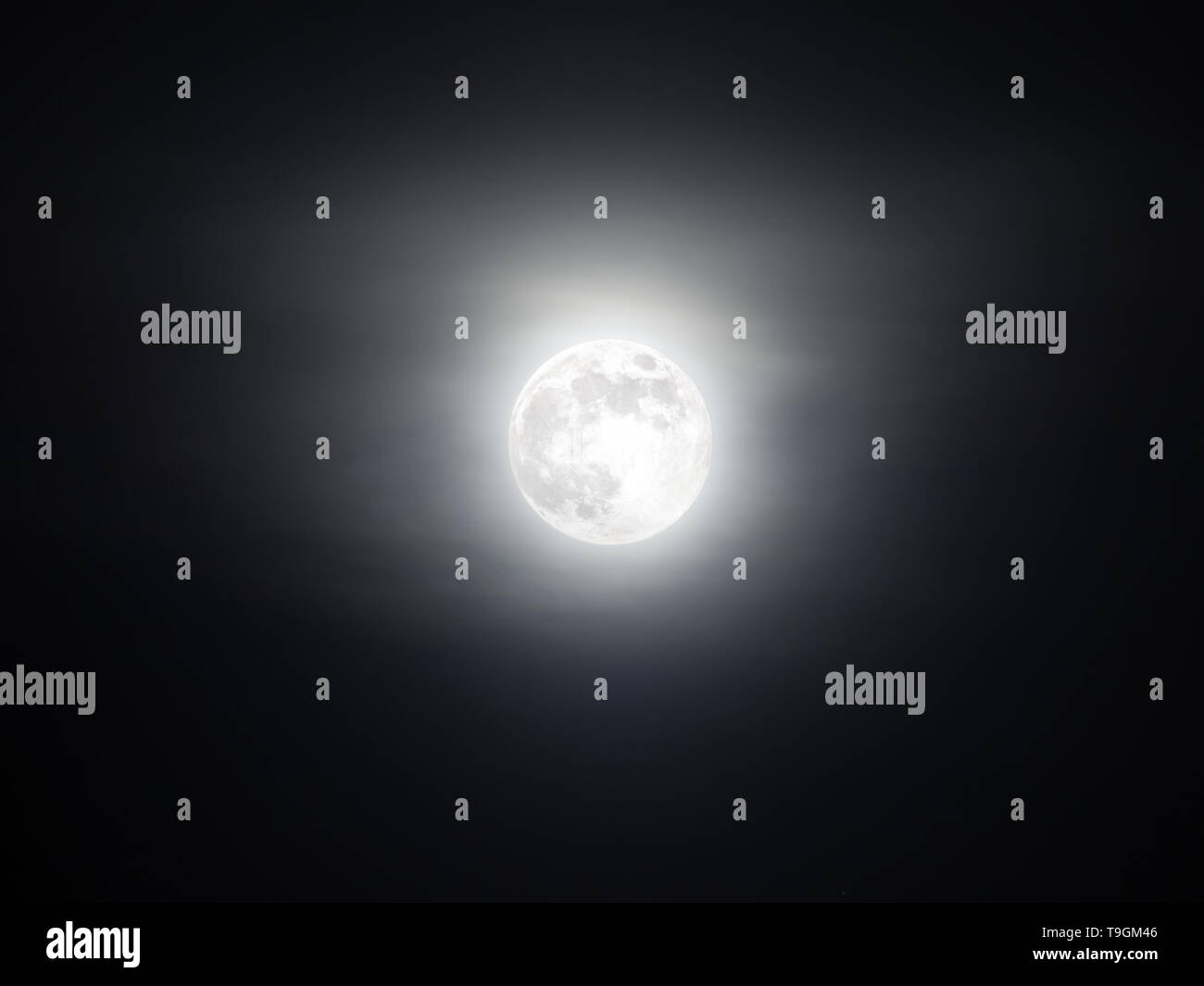 Foggy sky with the bright full moon glowing in the dark Stock Photo - Alamy