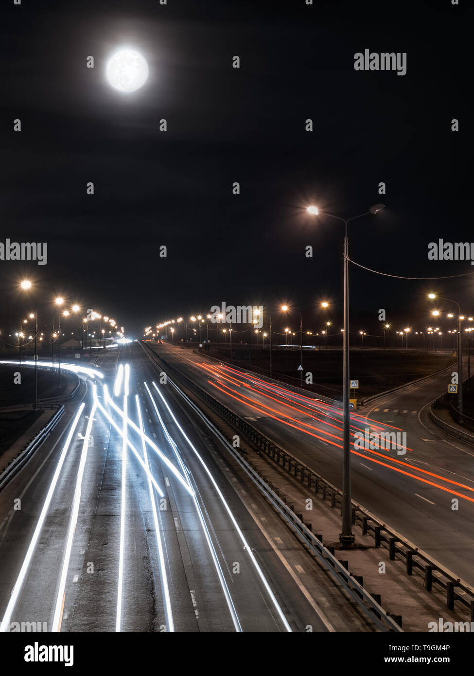 Night city traffic with the bright full moon in the foggy sky Stock ...