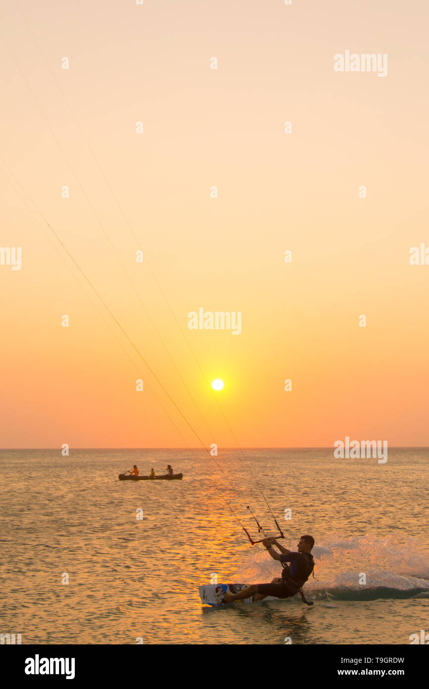Kite boarding at sunset, Caye Caulker, Belize Stock Photo - Alamy