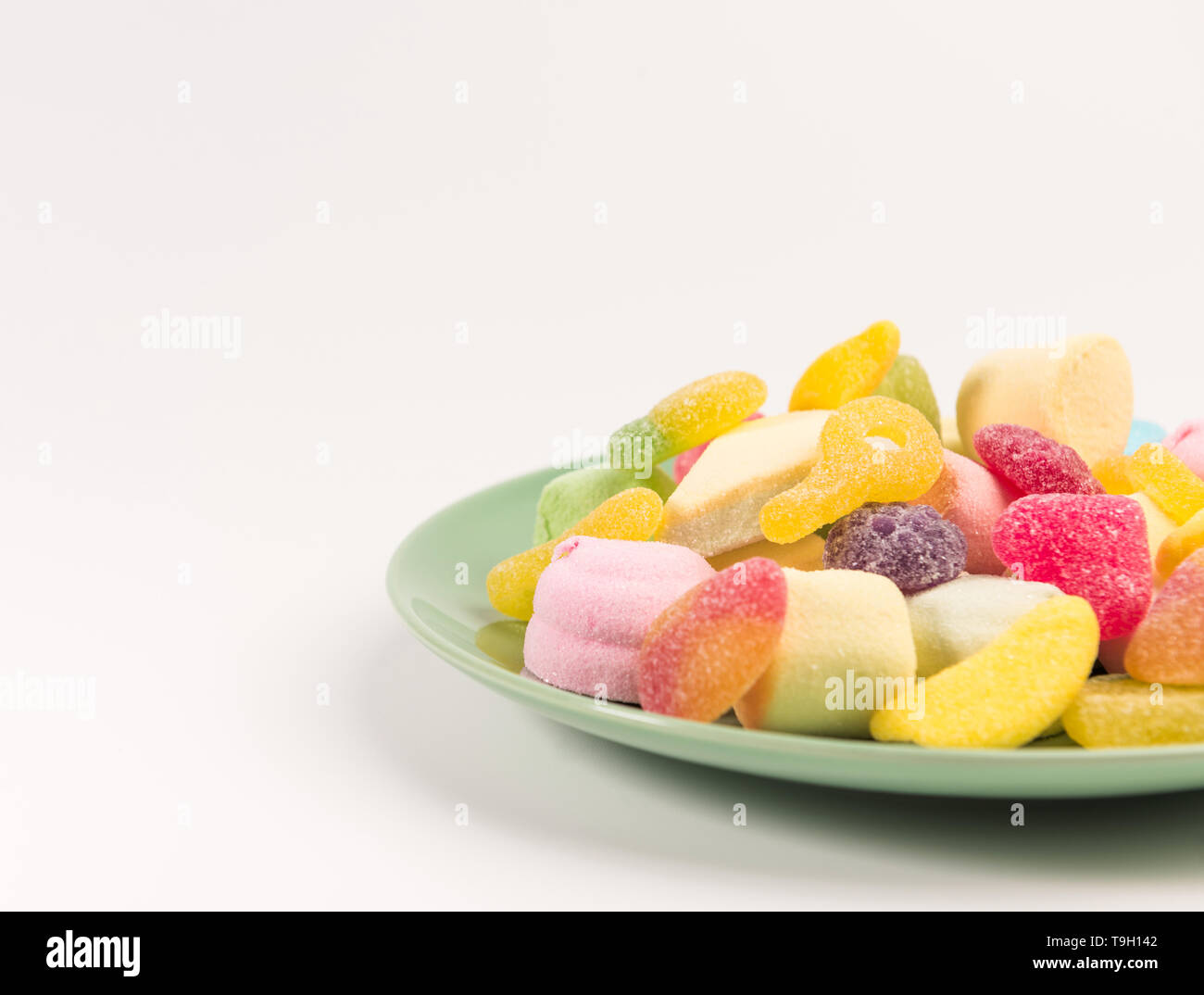 Plate with sweets isolated on a white background. Gummy candies and ...