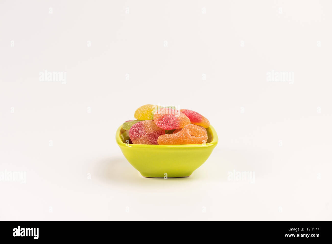 Small bowl with gummy candies isolated on white background Stock Photo ...