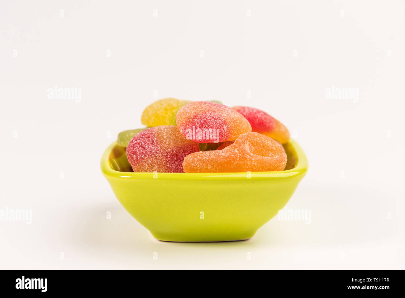 Small bowl with gummy candies isolated on white background Stock Photo ...